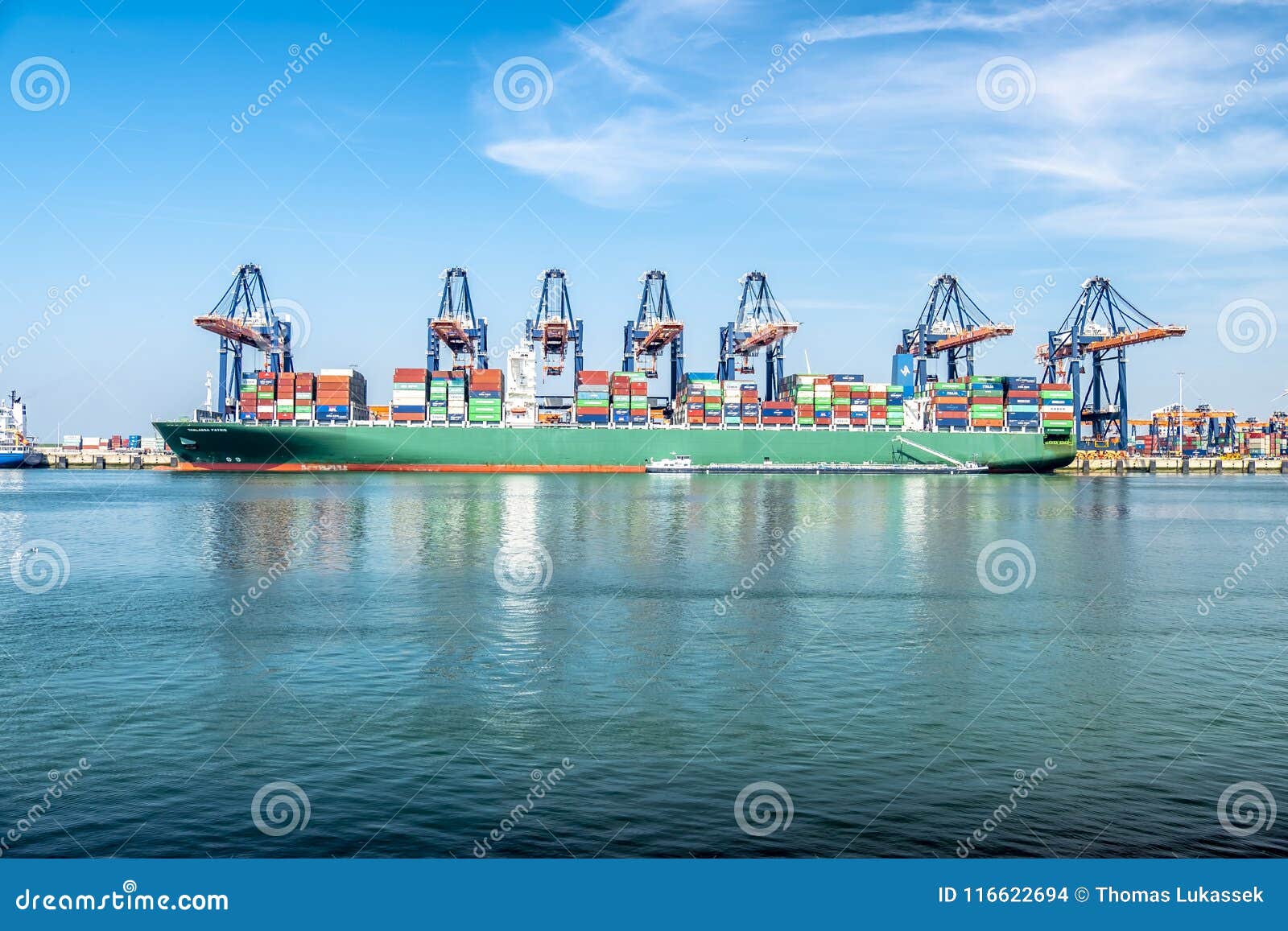 Rotterdam , Netherlands - April 20 2018 : Large Harbor Cranes Loading ... Rotterdam , Netherlands - April 20 2018 : Large Harbor Cranes Loading ...