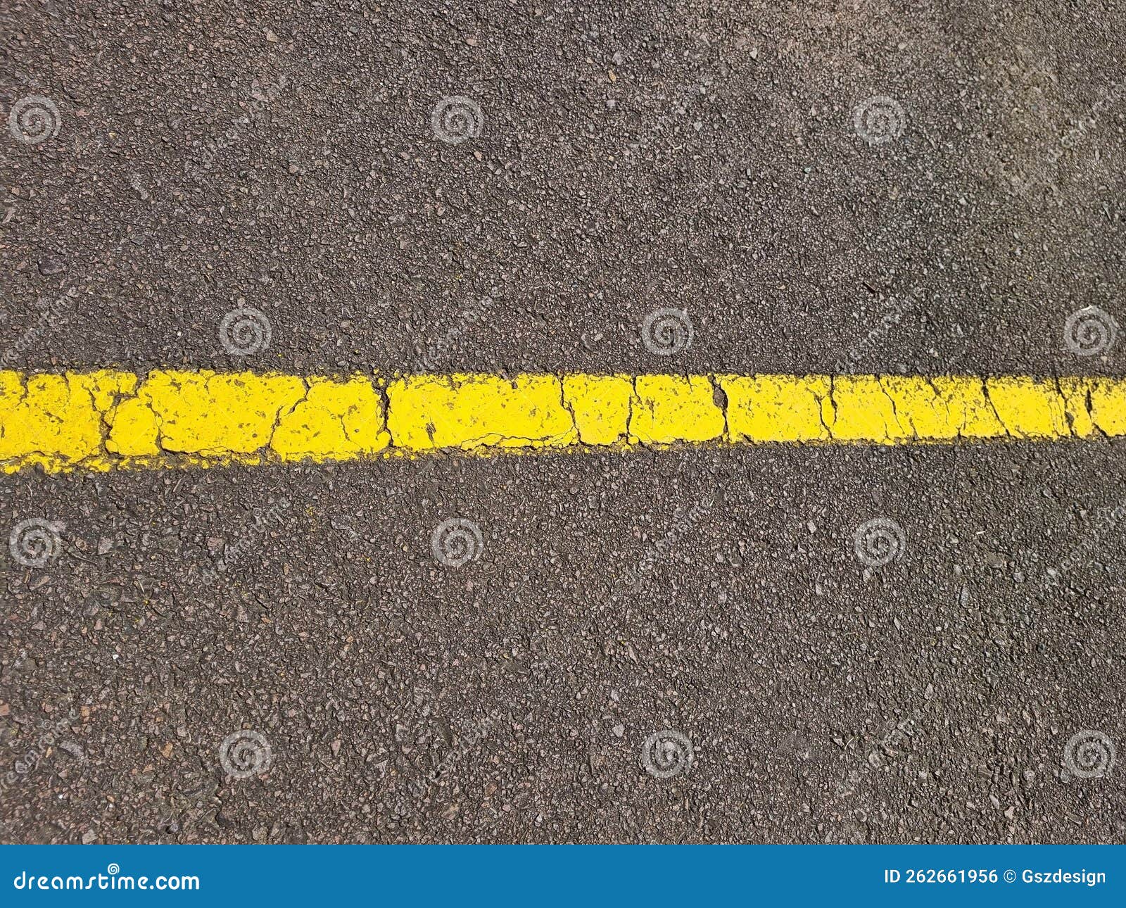 A Rough, Gray Asphalt with a Yellow Stripe Already Worn Down by Use and ...