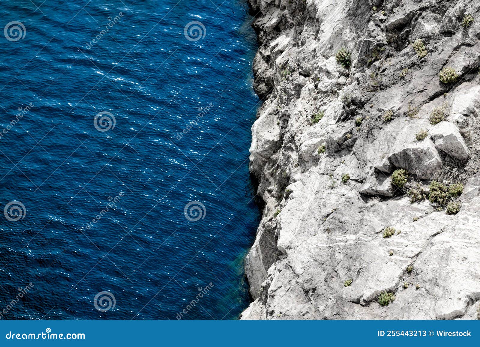 Rough Gray Cliff and Blue Water. Stock Image - Image of background ...