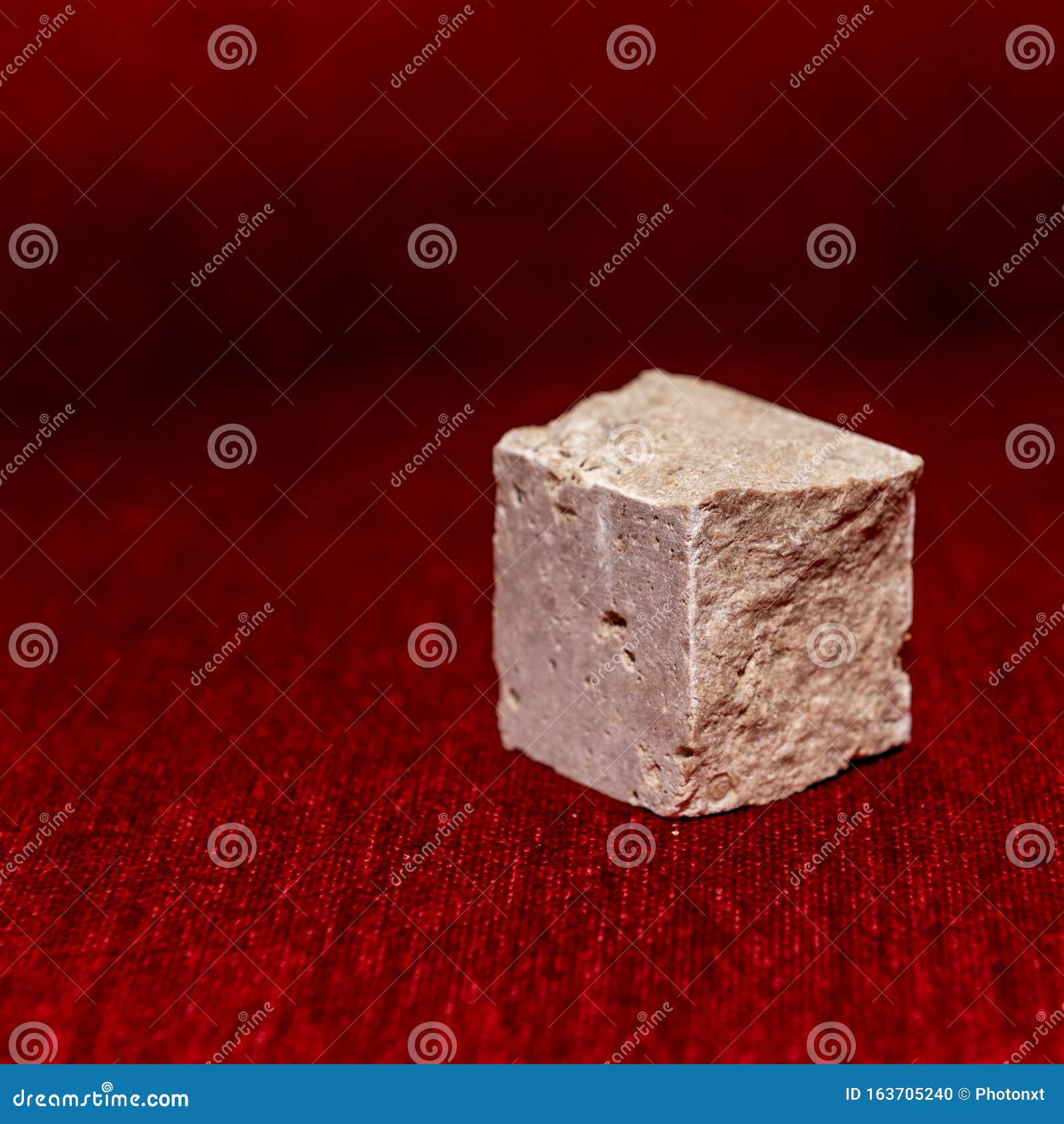 Rough Stone Cube Isolated on Blurred Red Background Stock Photo - Image ...