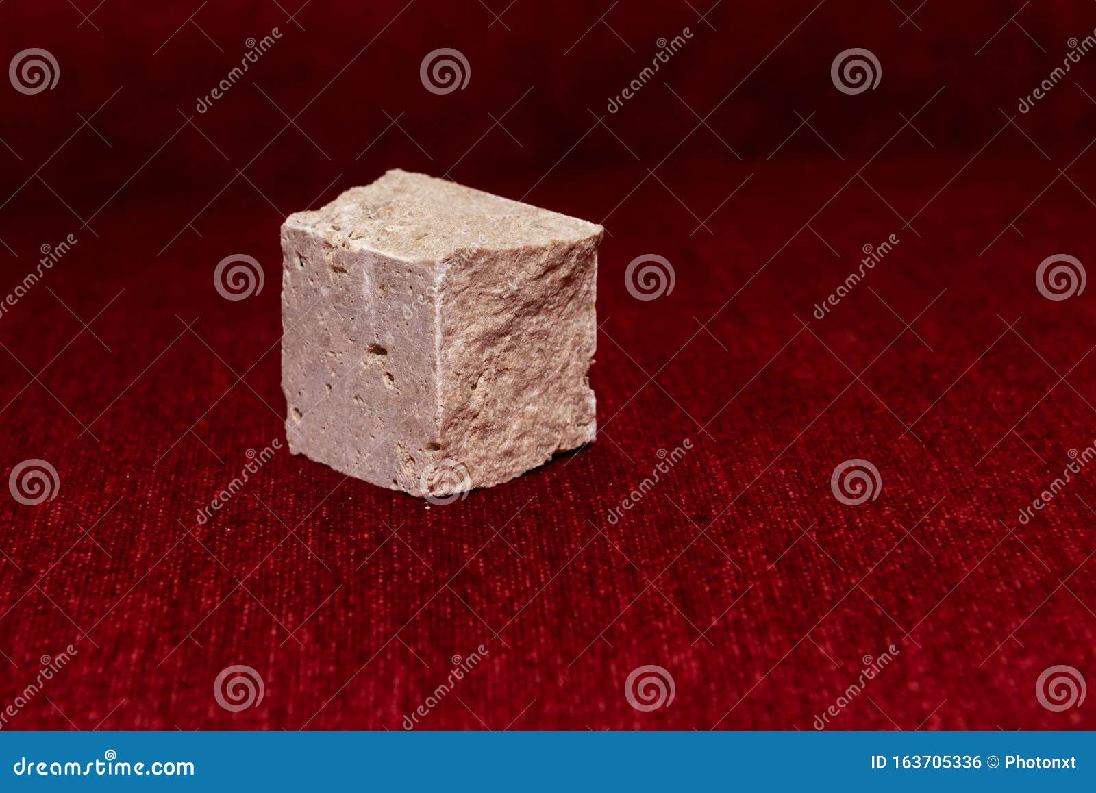 Rough Stone Cube Isolated on Blurred Red Background Stock Photo - Image ...