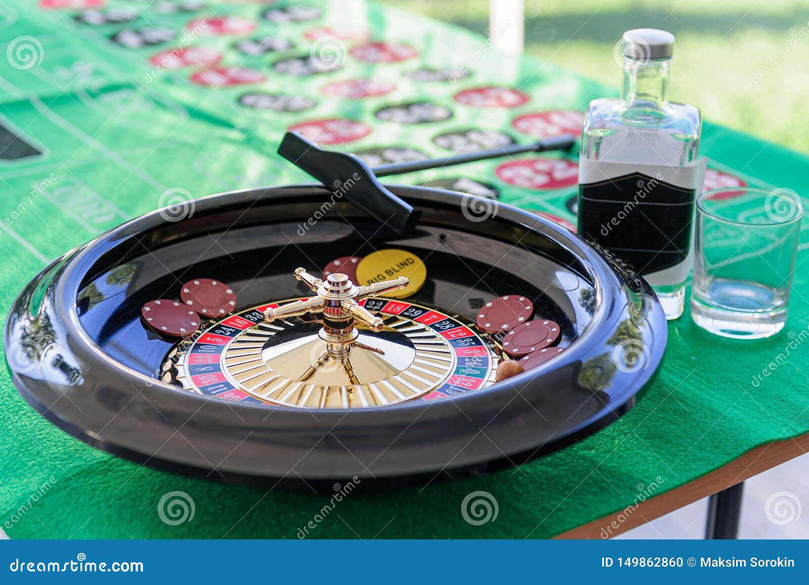 Roulette on the Table with a Glass and a Bottle Stock Photo - Image of ...