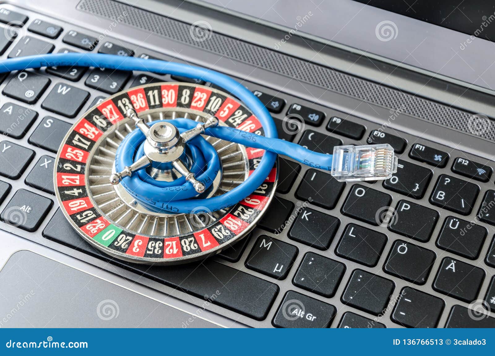Roulette Wheel and LAN Cable Lying on Computer Keyboard Symbolizing ...