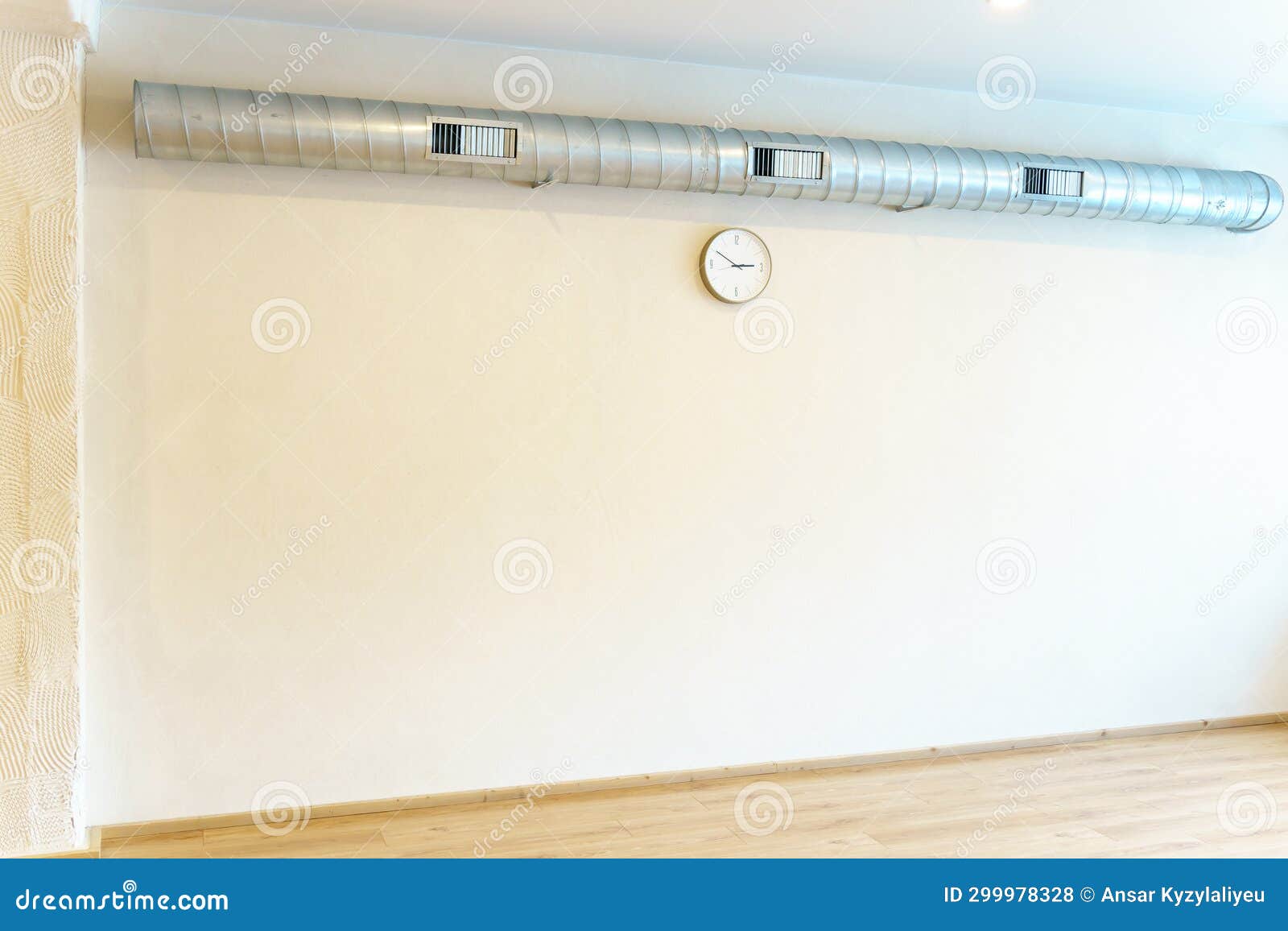 A Round Analog Clock on an Empty White Wall. a Ventilation Pipe Runs ...