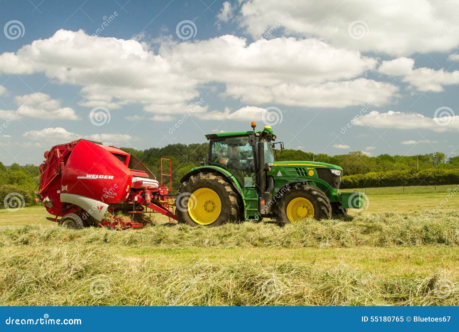 A Round Baler Pulled by a John Deere during Harvesting Editorial Image ...