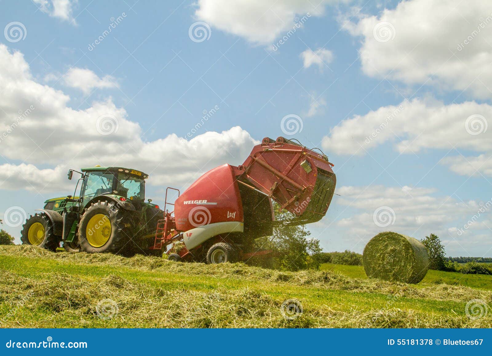 A Round Baler Pulled by a John Deere during Harvesting Editorial Stock ...