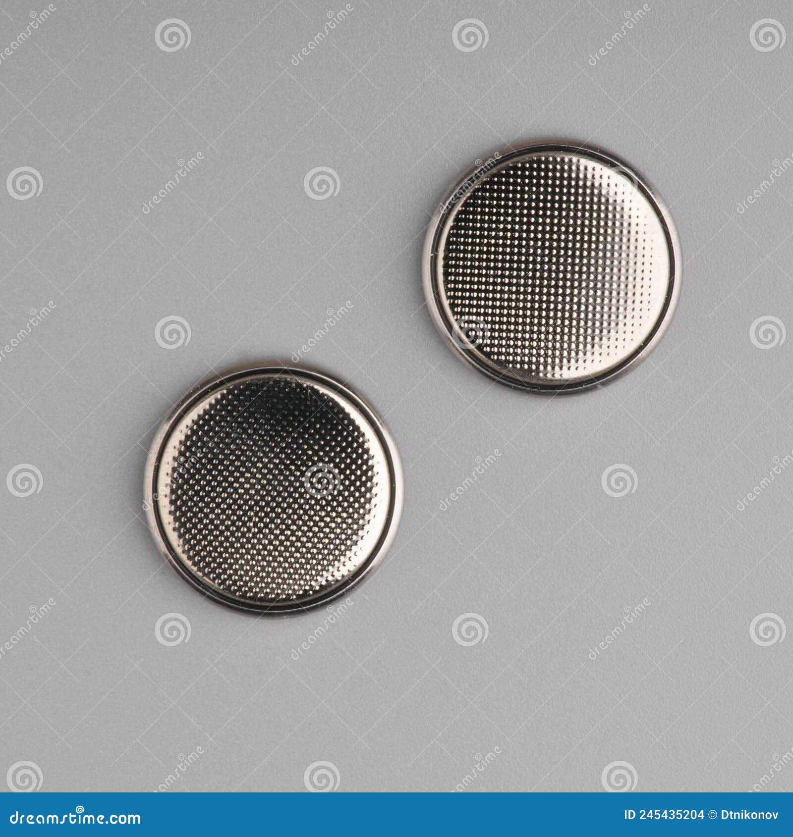 Round Batteries on a Gray Background. Closeup Stock Photo - Image of ...