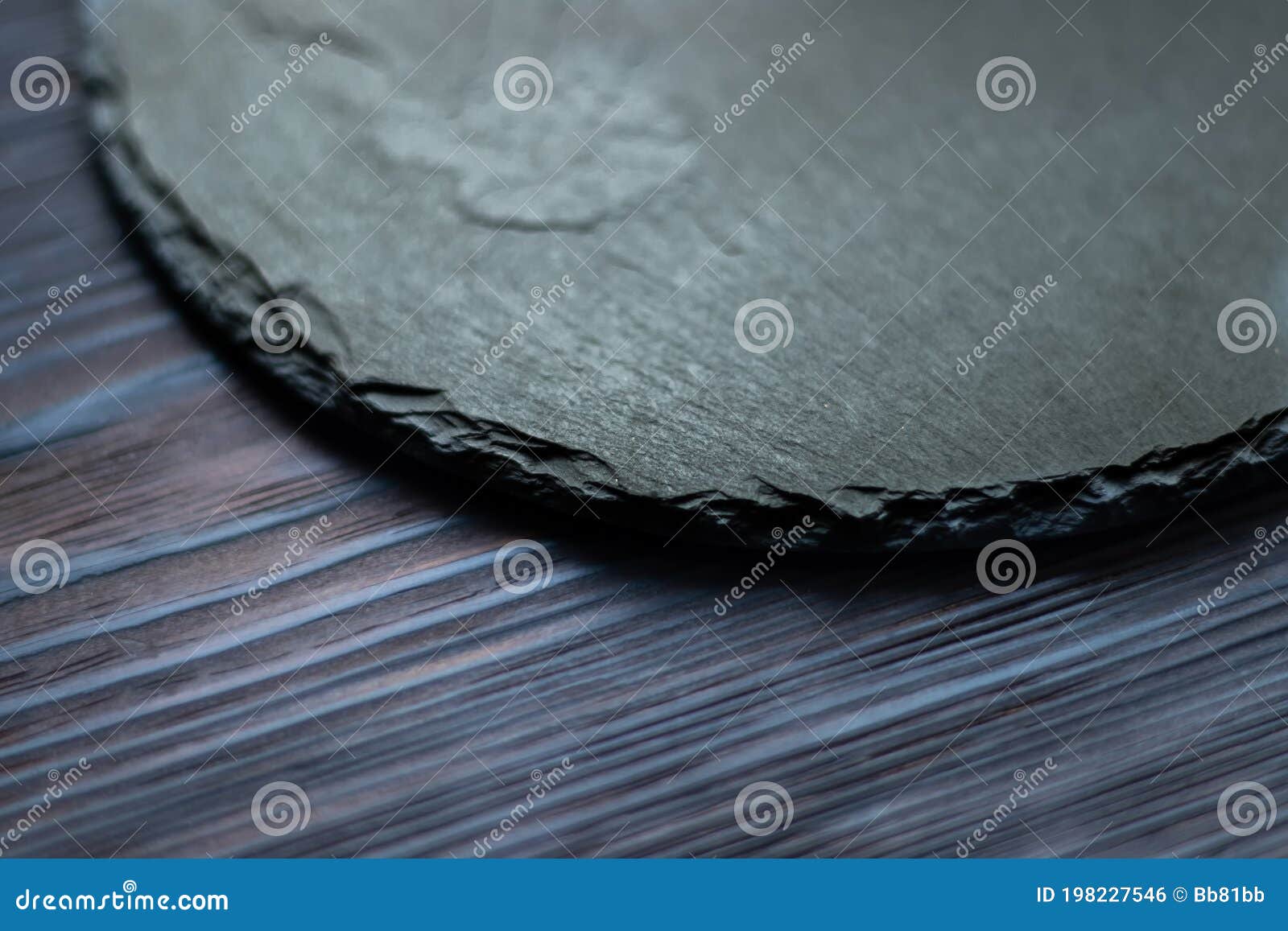 Round Black Slate Board on Wooden Table Stock Photo - Image of empty ...