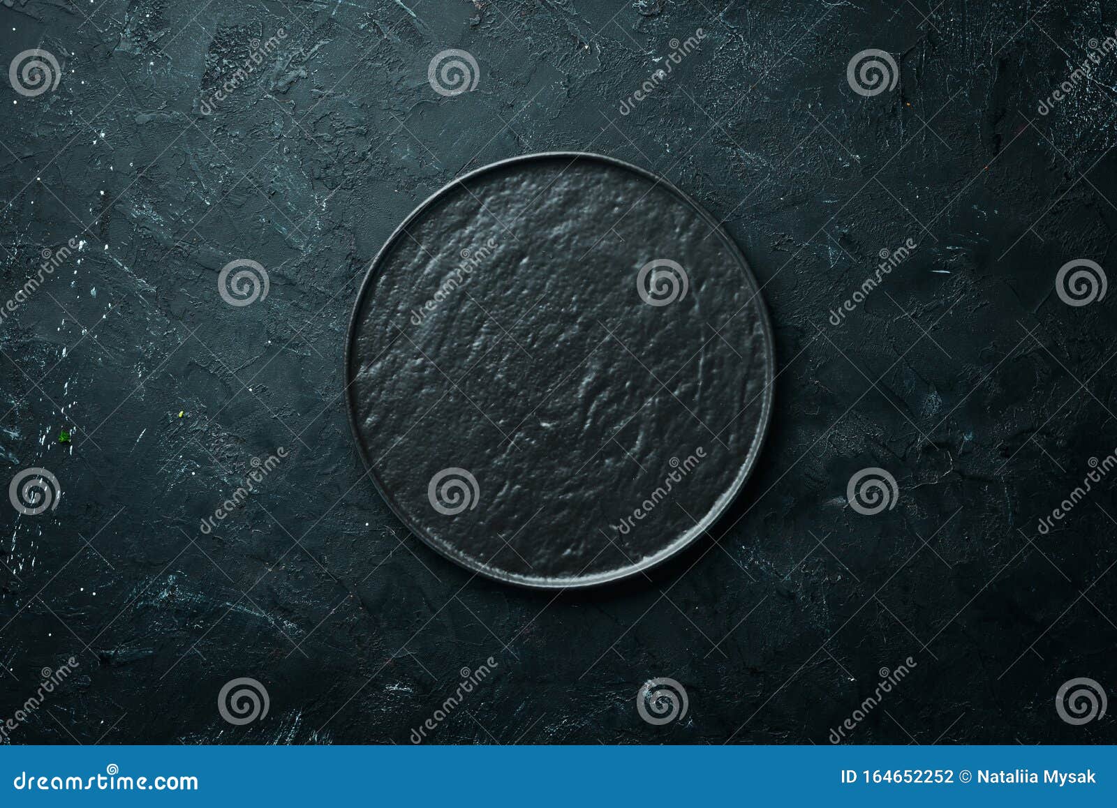 Round black stone plate. stock photo. Image of dishware - 164652252