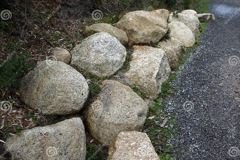 Round Boulder Stone Wall Along Path Edge Stock Image - Image of ...