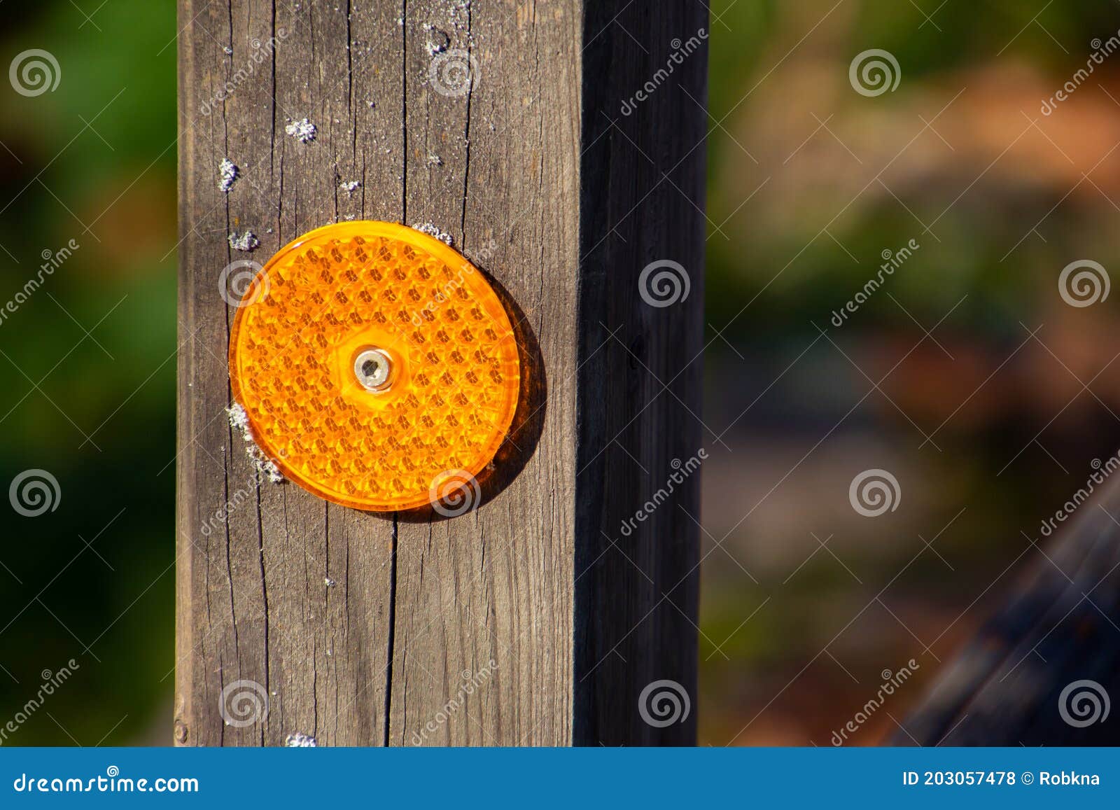 Round Bright Orange Plastic Reflector on a Wooden Post Stock Photo ...