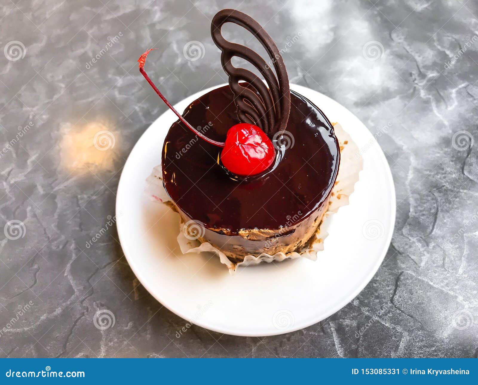 Round Cake with Chocolate Icing and Cherry Stock Image - Image of plate ...