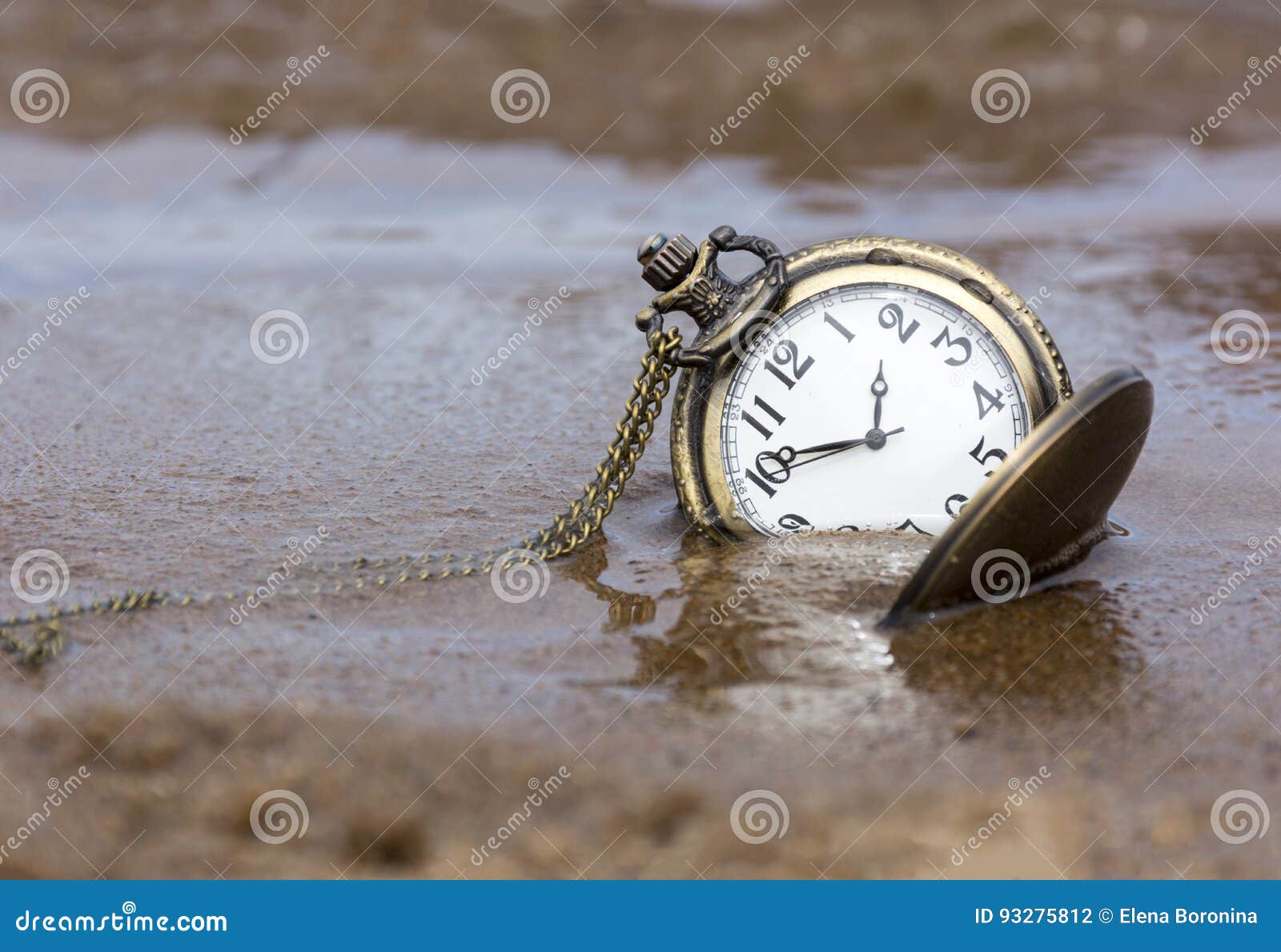 Round Clock with Hands Lying on the Wet Sand, Water, Time Stock Photo ...