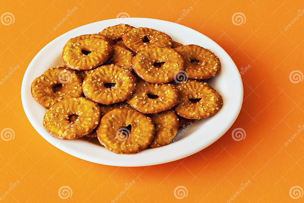 Round Crackers with a Hole and Salt on an Orange Background Stock Photo ...