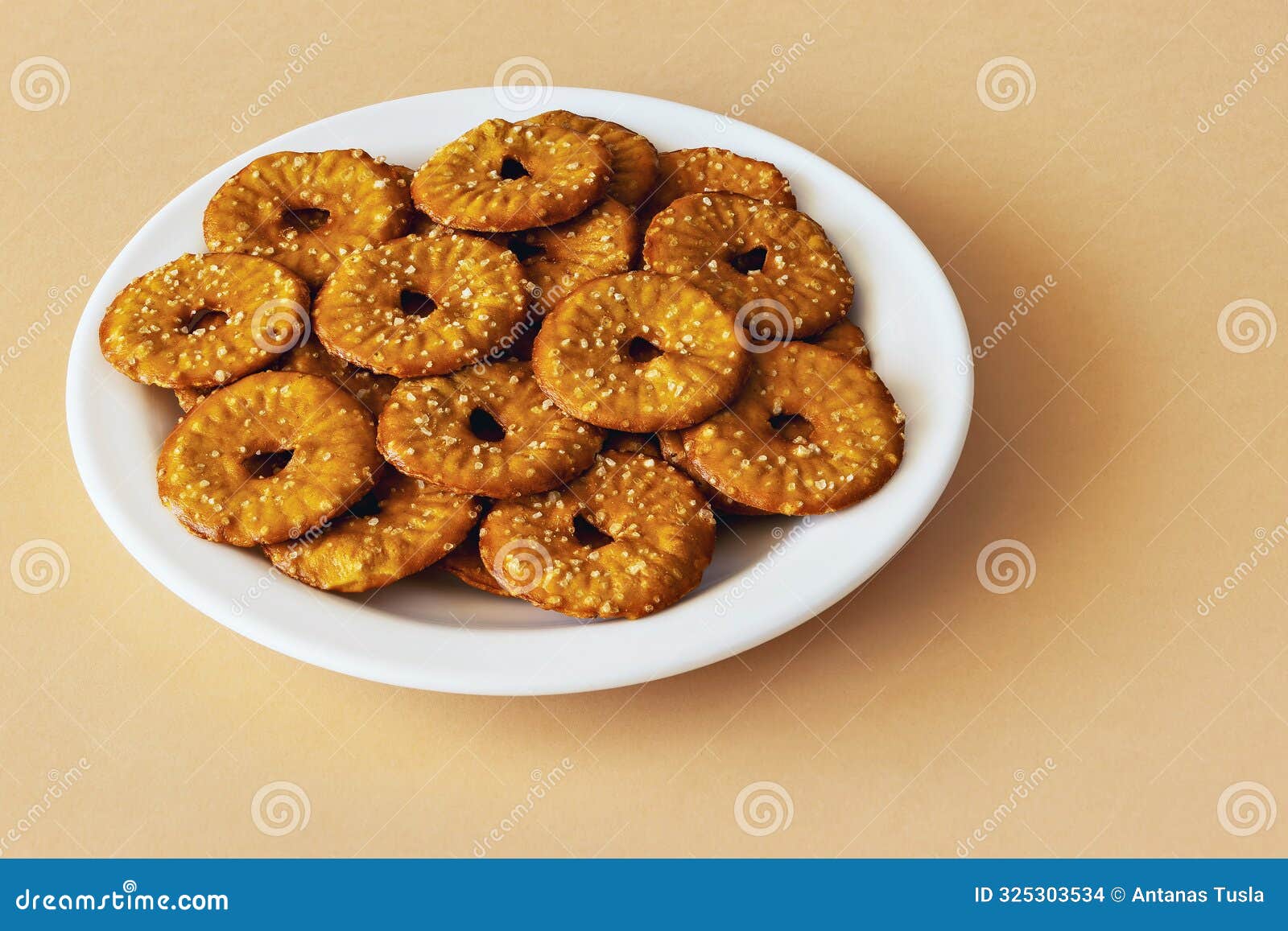 Round Crackers with a Hole and Salt on an Orange Background Stock Photo ...