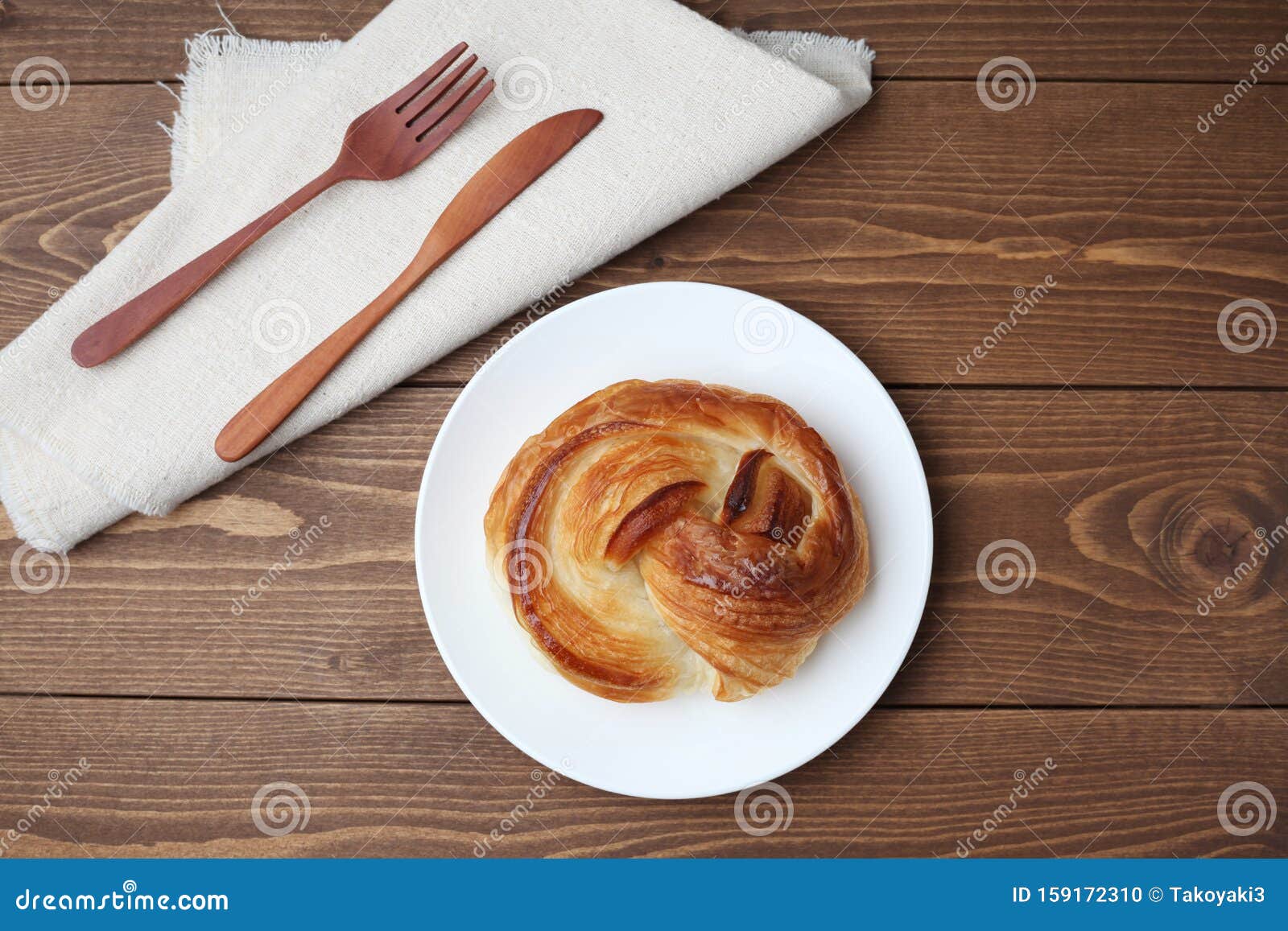 Round Danish Bread on Plate on Wooden Table Stock Photo - Image of fork ...