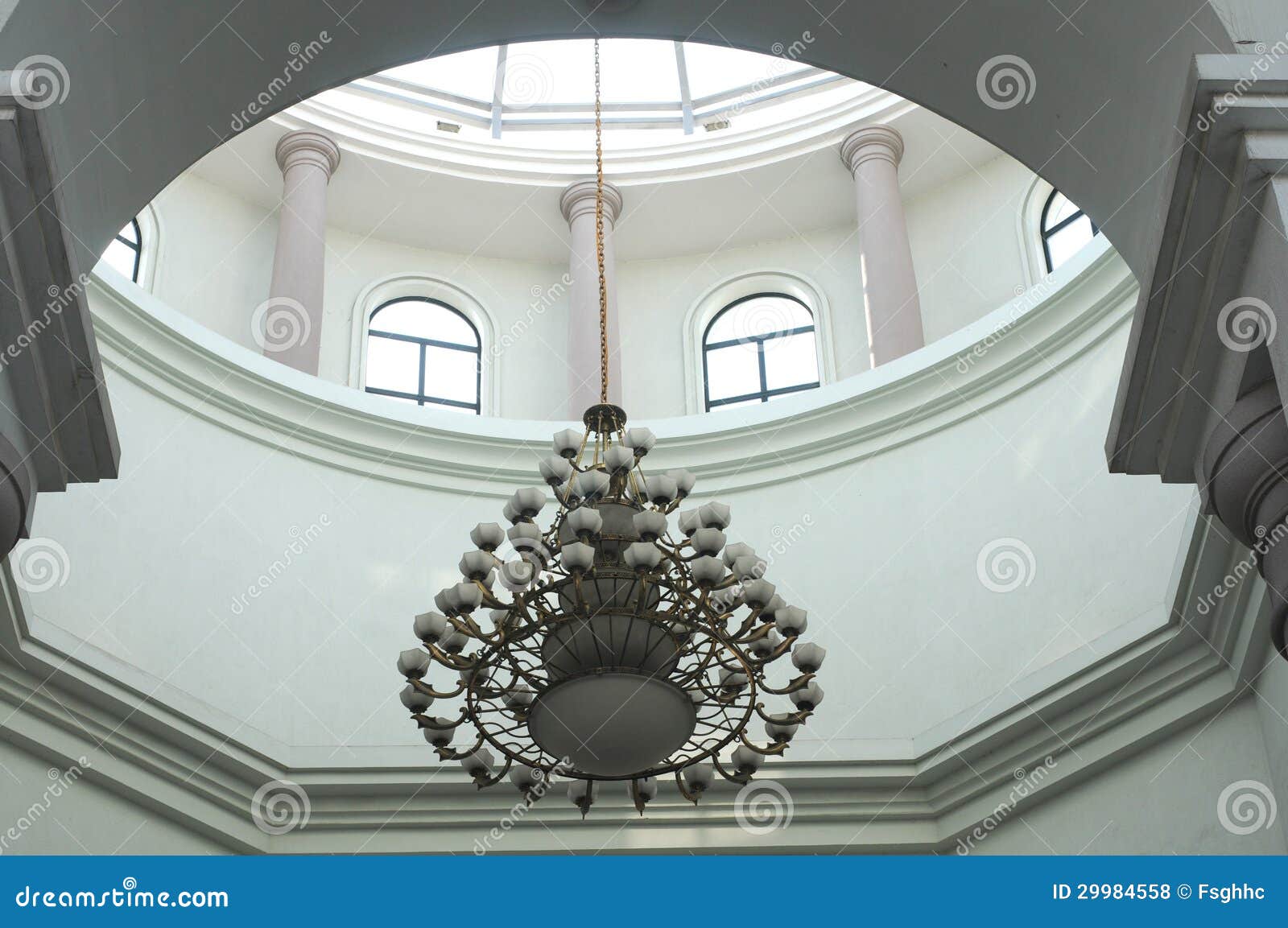 A Round Drop Light with a Golden Chain Hanging on a Glass Dome Stock ...