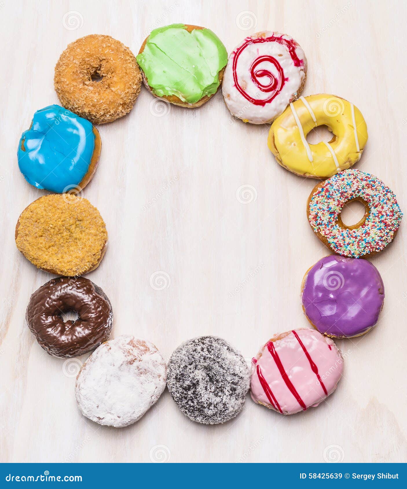 Round Frame of Colorful Doughnuts on White Wooden Background, Top View ...