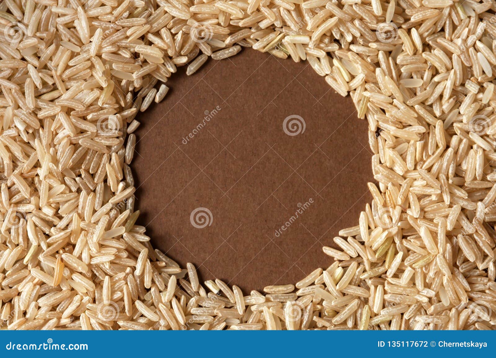 Round Frame Made with Brown Rice on Color Background. Stock Photo ...