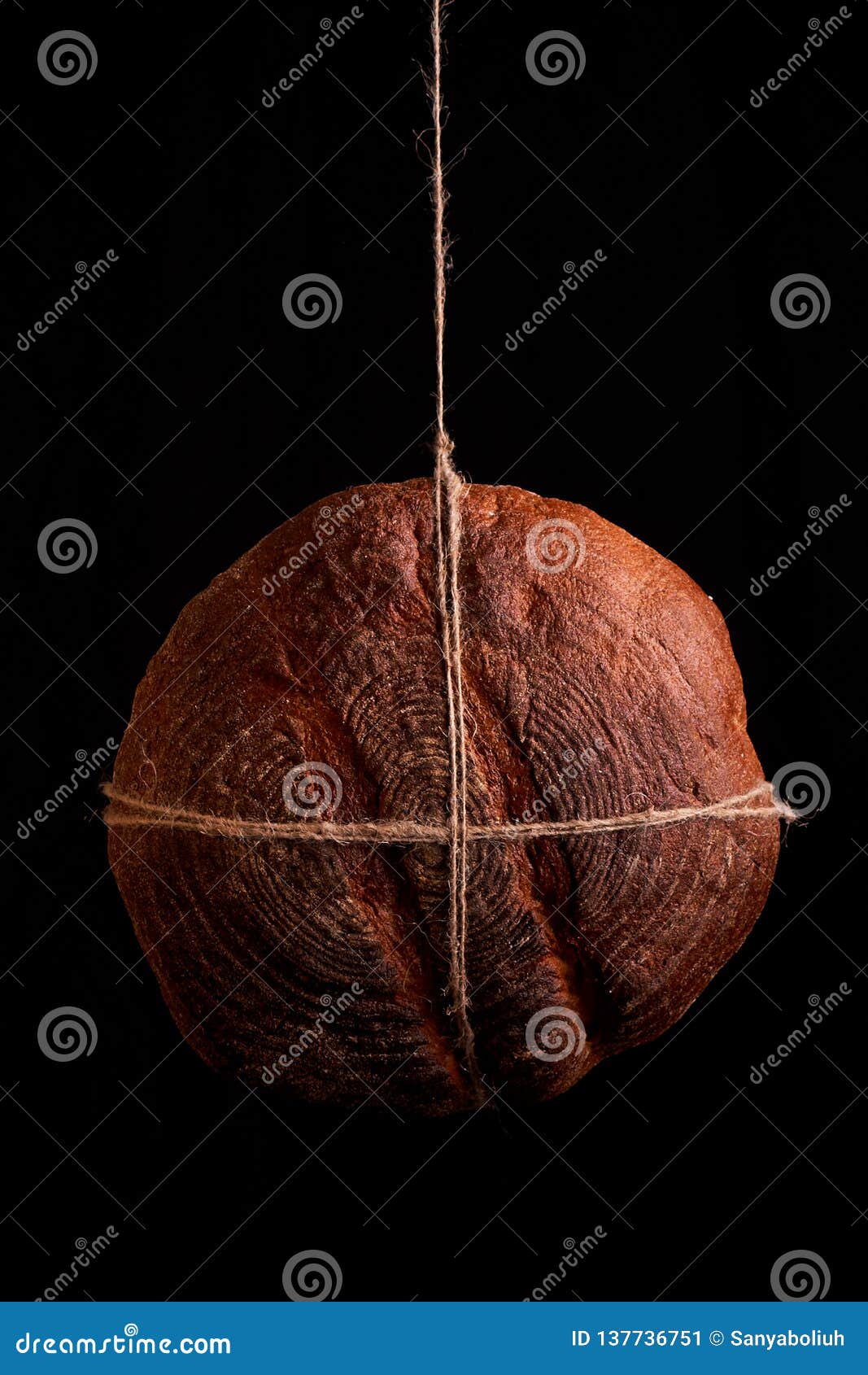 Round Fresh Bread Hanging on a Rope on a Black Background. Copy Space ...