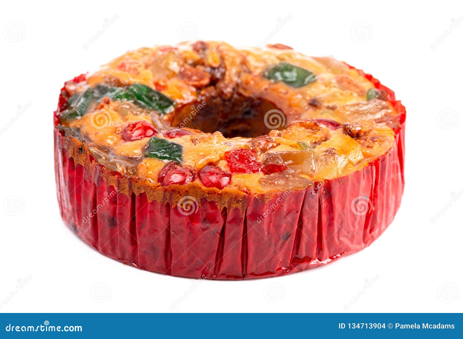 A Round Fruit Cake with Cherries Pineapples and Nuts on a White ...