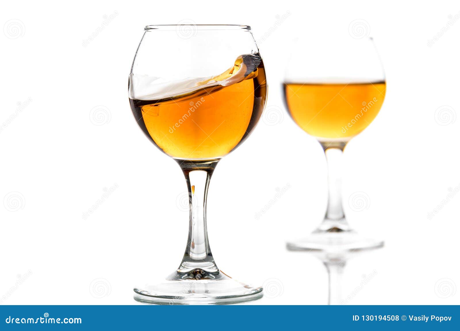 A Round Glass with Brandy and a Splash of Drink Inside Stock Photo ...