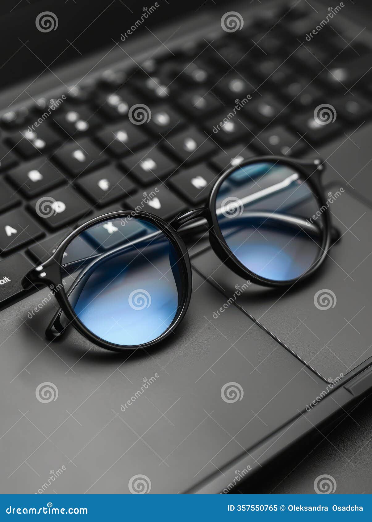 Round Glasses with Blue Lenses on a Laptop Keyboard. Stock Image ...