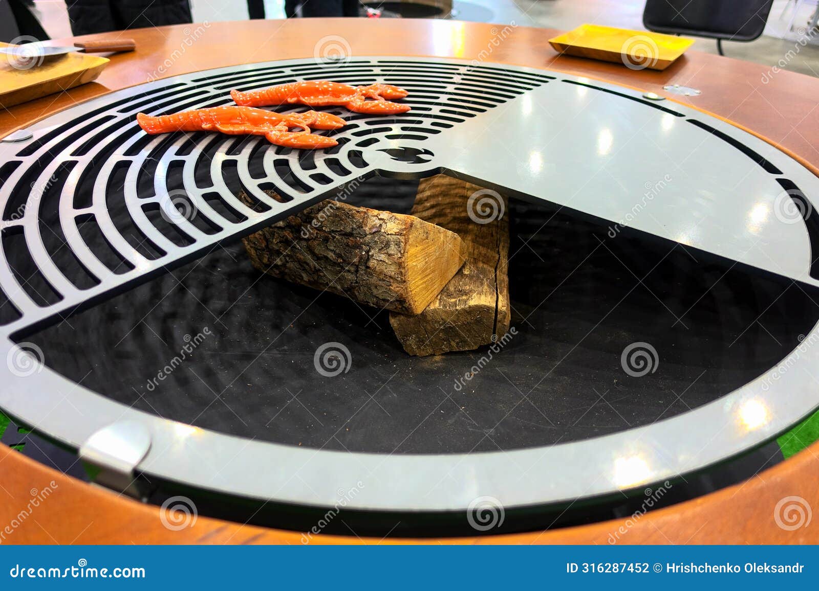 Round Grill Surrounded by a Wooden Dining Table Stock Photo - Image of ...