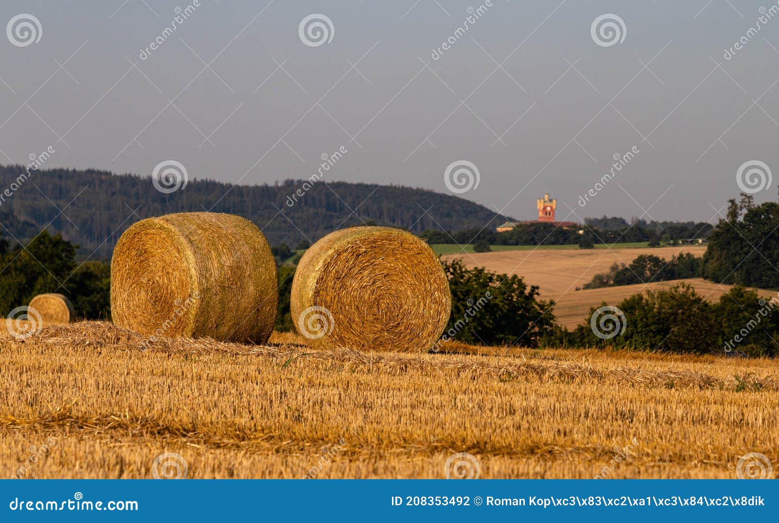 Round Haystack on a Cropped Field with Castle in Background Stock Photo ...