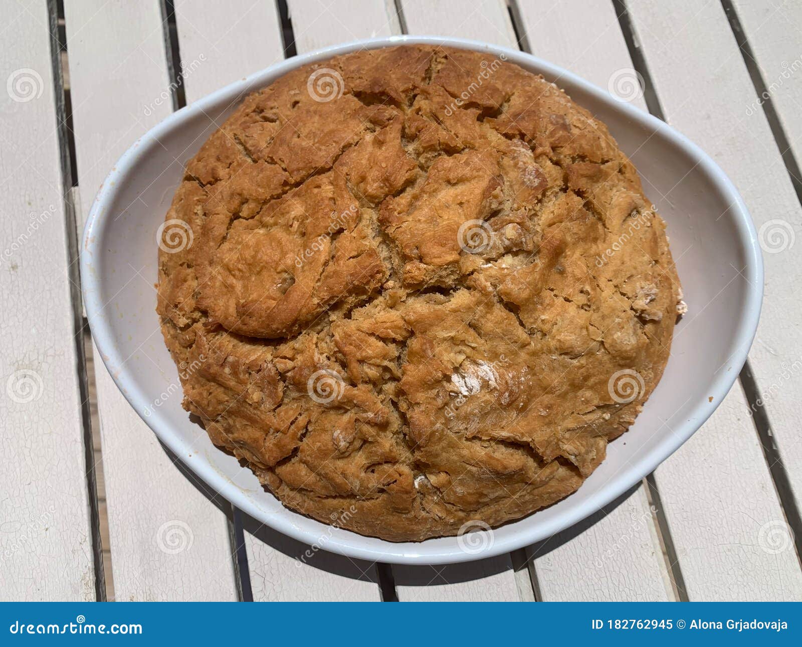 Round Home Made Dark Bread in a White Plate. Horizontal Image Stock ...