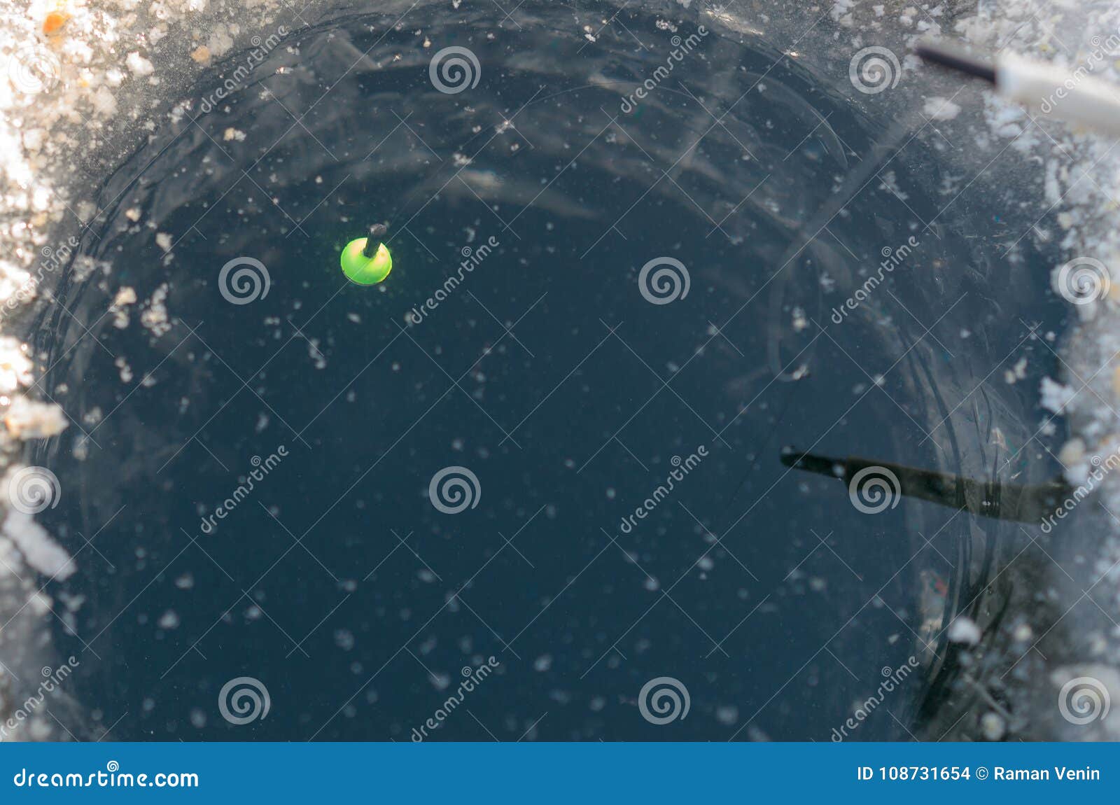 Round Ice in the Ice with a Float on the Line. Stock Photo - Image of ...