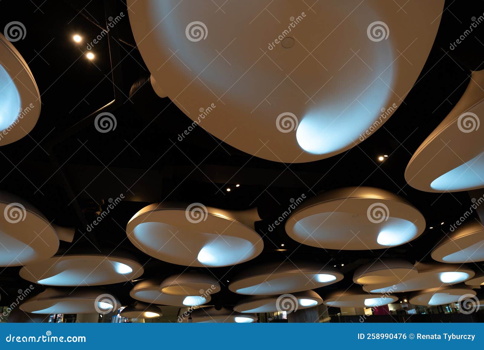 Round Lamp Shades Attached To Ceiling with Soft Light in a Cafe Stock ...