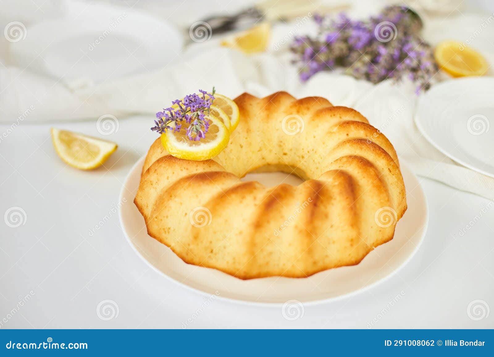 Round Lemon Cake on White Table with Lavender Stock Photo - Image of ...