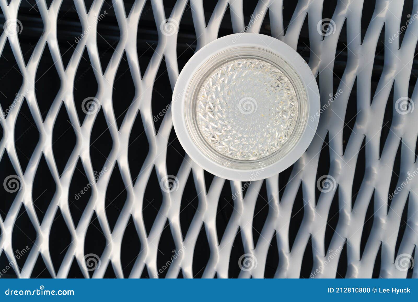 A Round Light Hanging from the Ceiling of a Gray Twisted Mesh Stock ...