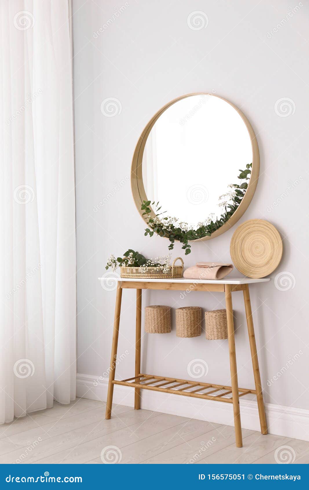 Round Mirror and Table with Accessories Near White Wall Stock Image ...