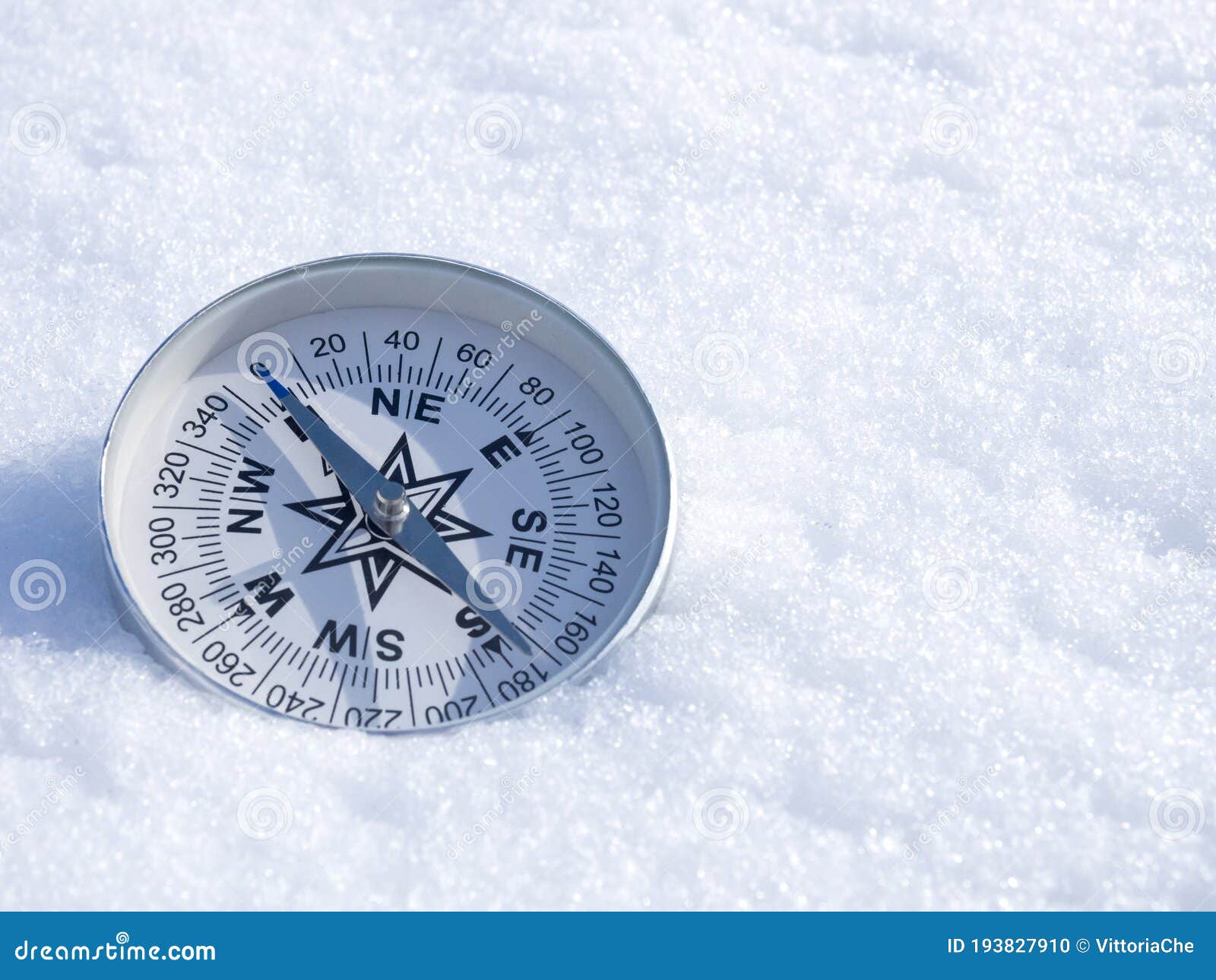 Round Modern Compass on the White Snow, Space for Text. Concept for ...