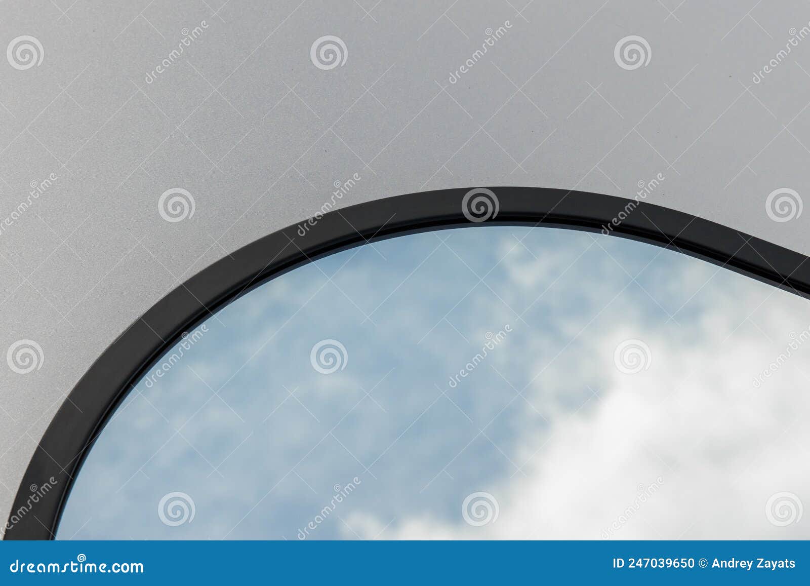 A Round or Oval Mirror with a Reflection of the Blue Sky and White ...