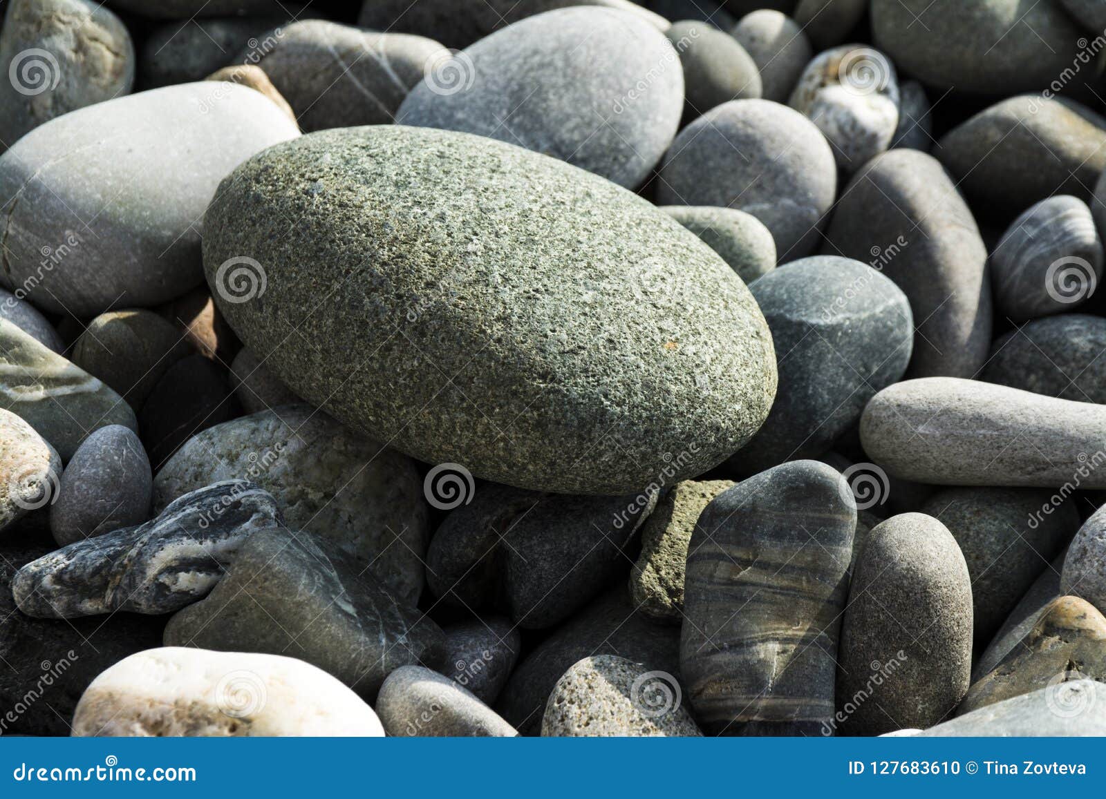 Round pebbles on the beach stock photo. Image of stone - 127683610