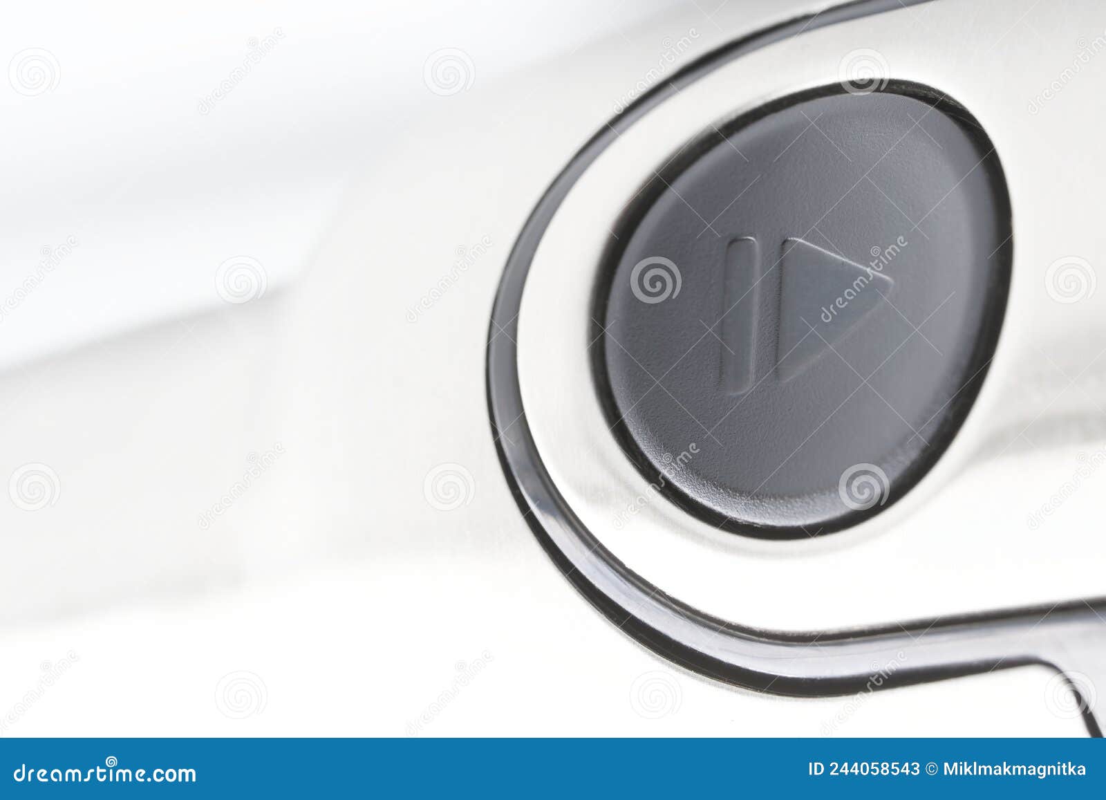 Round Play and Pause Button on a Light Polished Metal Surface of a ...