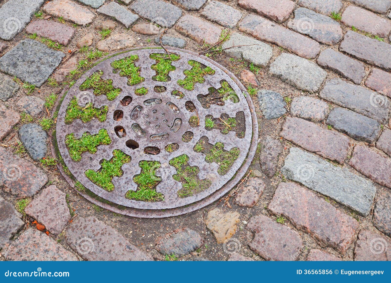 Round Sewer Manhole on Stone Pavement Stock Photo - Image of detail ...