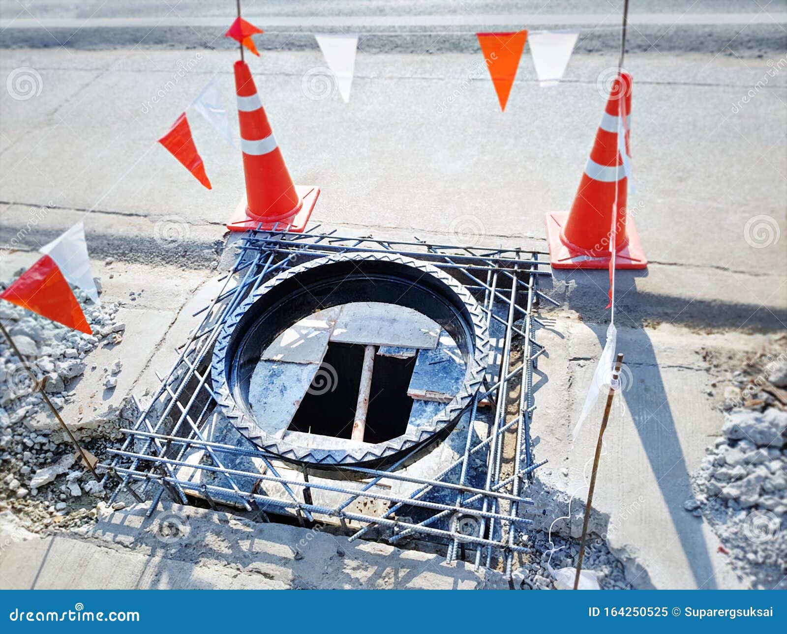 Round Sewer Manhole Under Construction with Road Cones As Warning ...