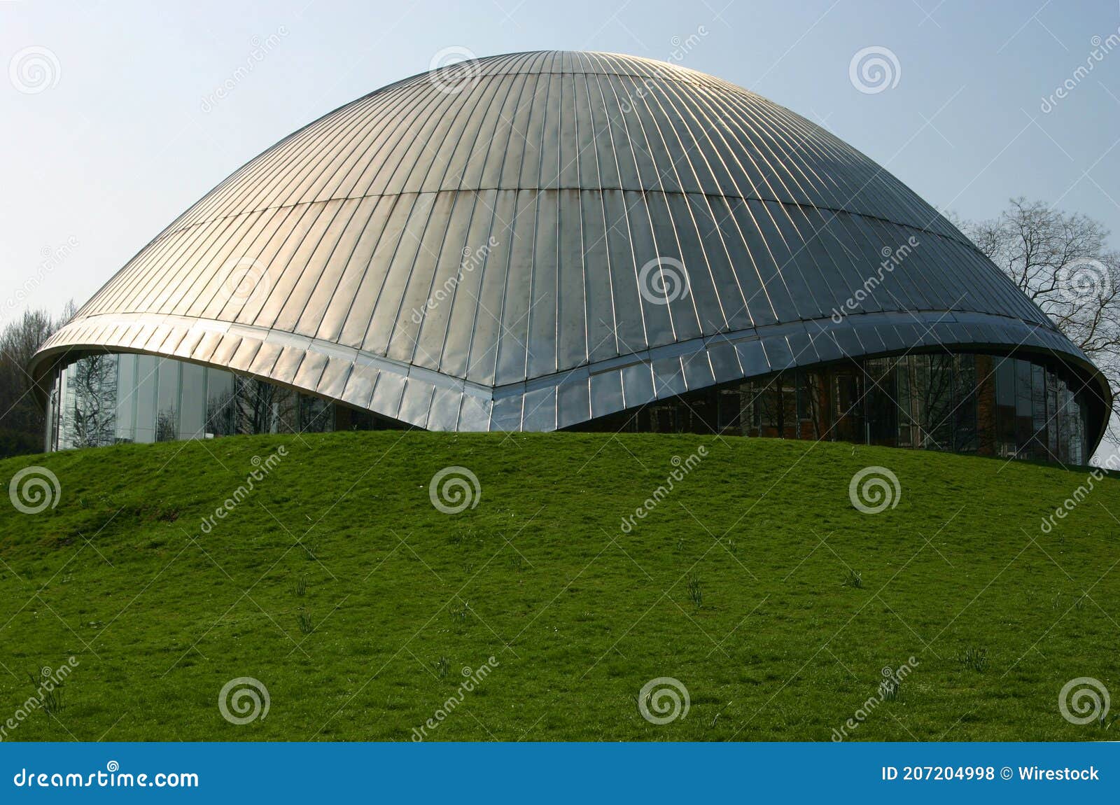 Round-shaped Building with a Metal Round Dome and Surrounded by Green ...