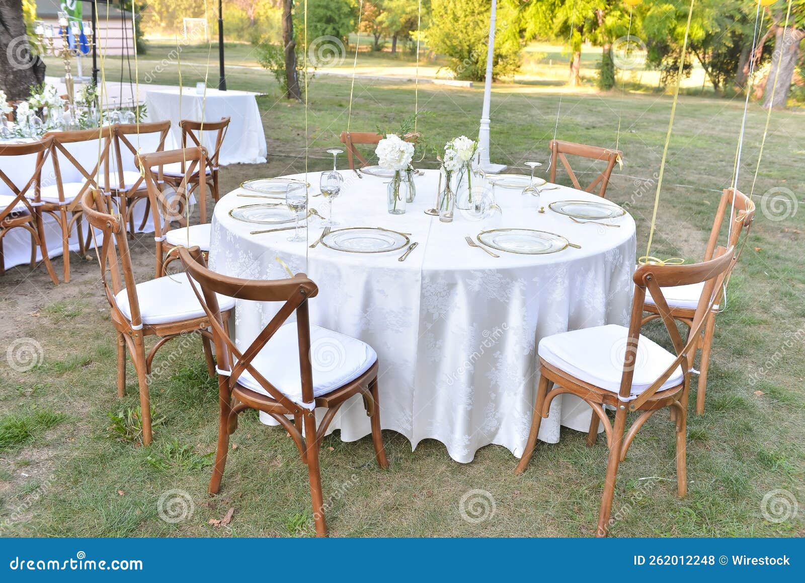 Round-shaped Table with a White Tablecloth Decorated with Table ...