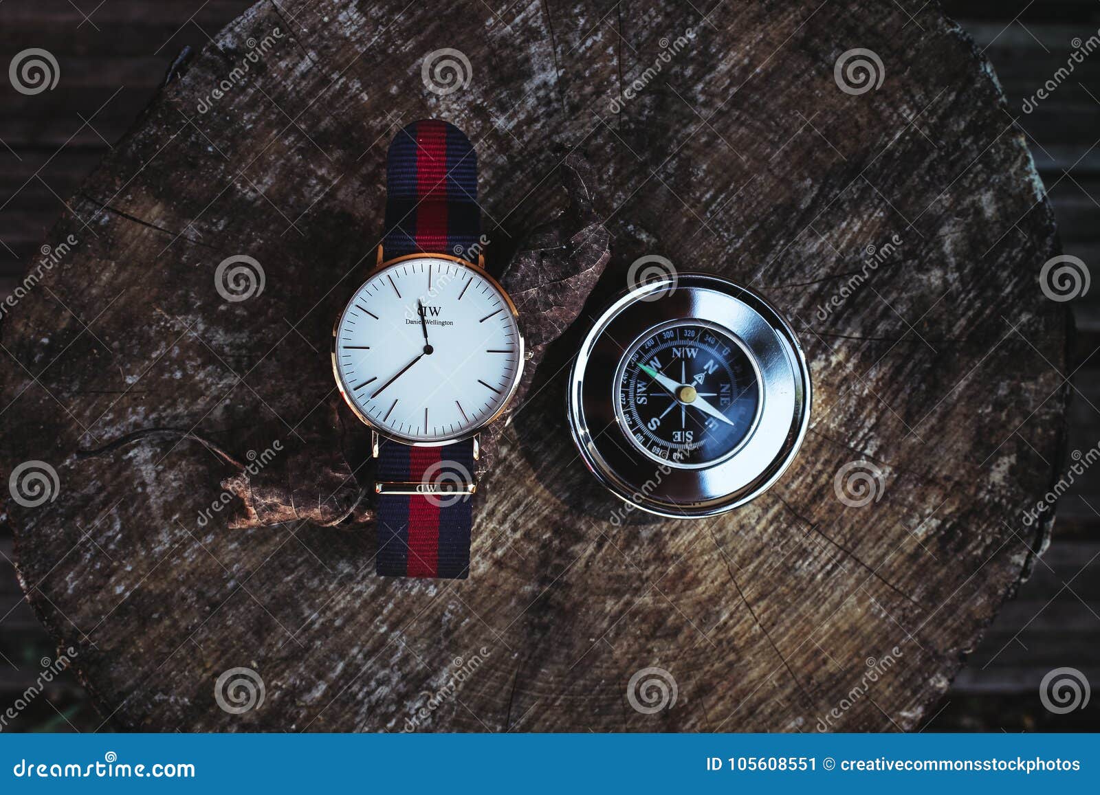 Round Silver-colored Analog Watch Beside Compass Picture. Image: 105608551