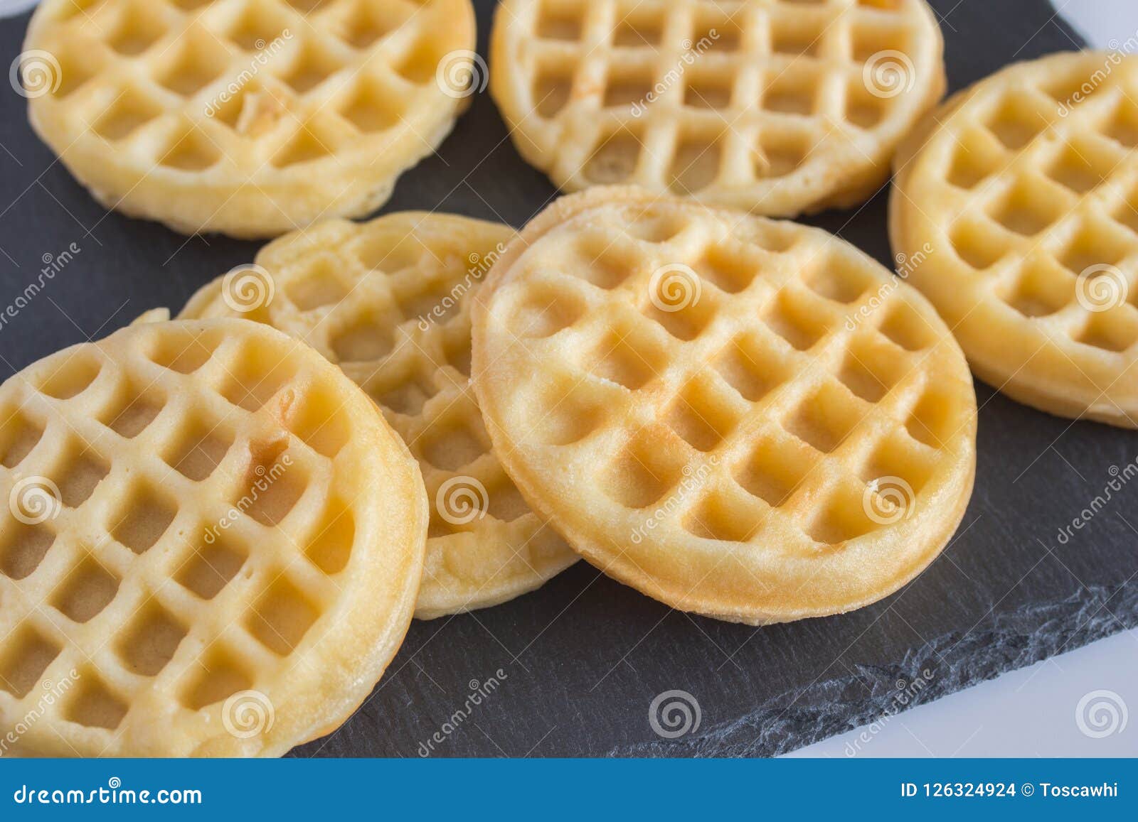 Round Small Waffles on Black Slate Board with Selective Focus Stock ...