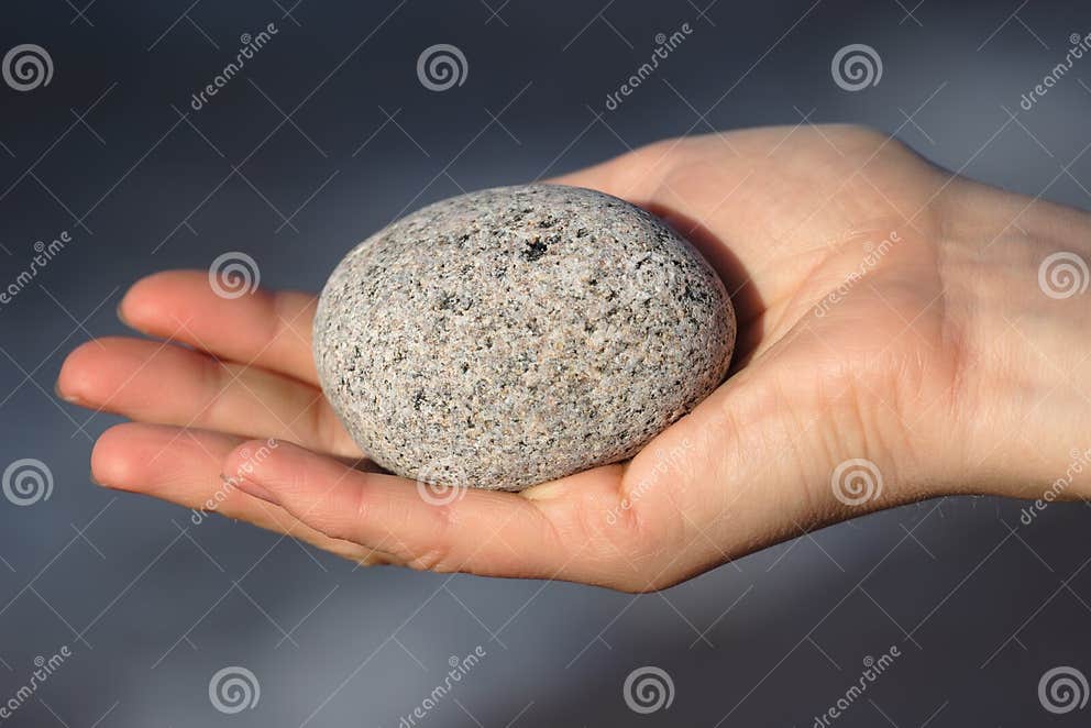 Round stone in hand stock image. Image of female, blue - 6962431