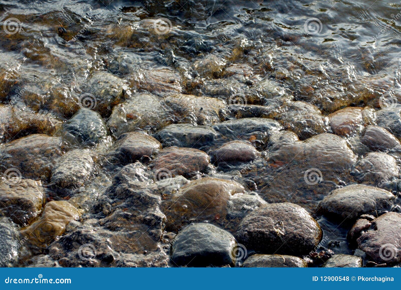 Round stones and water stock photo. Image of pavement - 12900548
