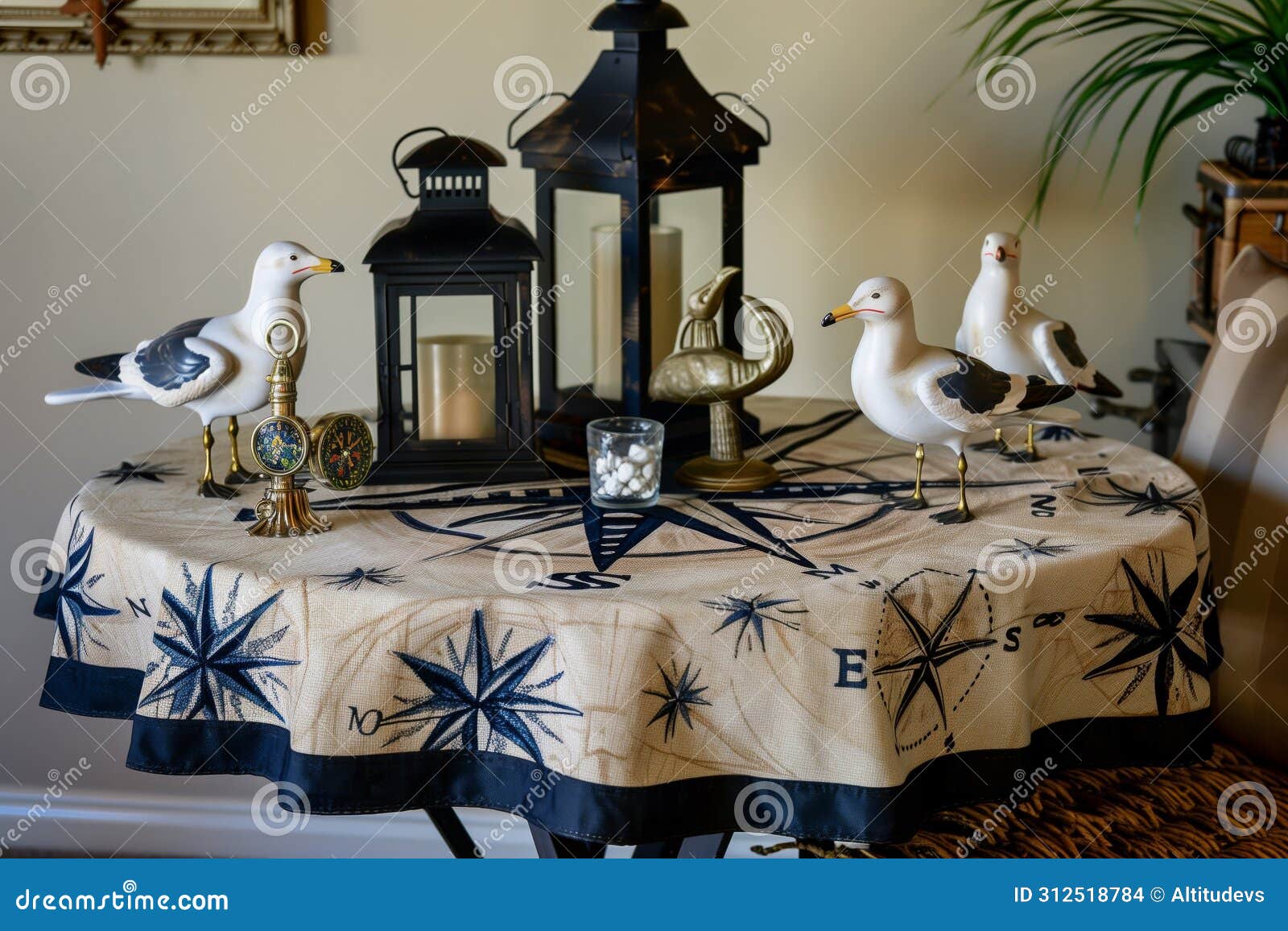 Round Table with a Compassdesigned Tablecloth, Seagull Figurines, and a ...