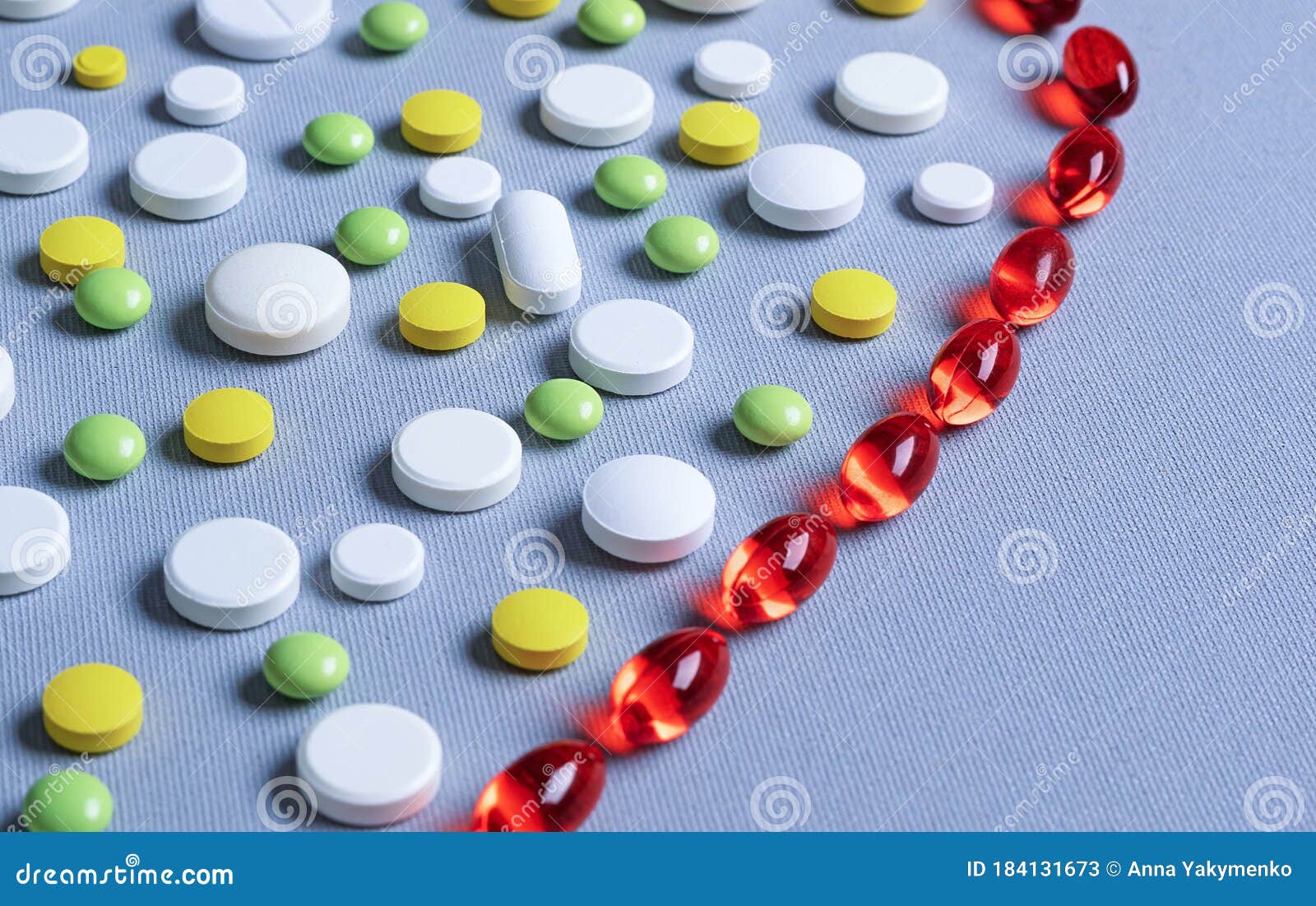 Round Tablets of Different Sizes with Red Capsules. Pharmaceutical ...