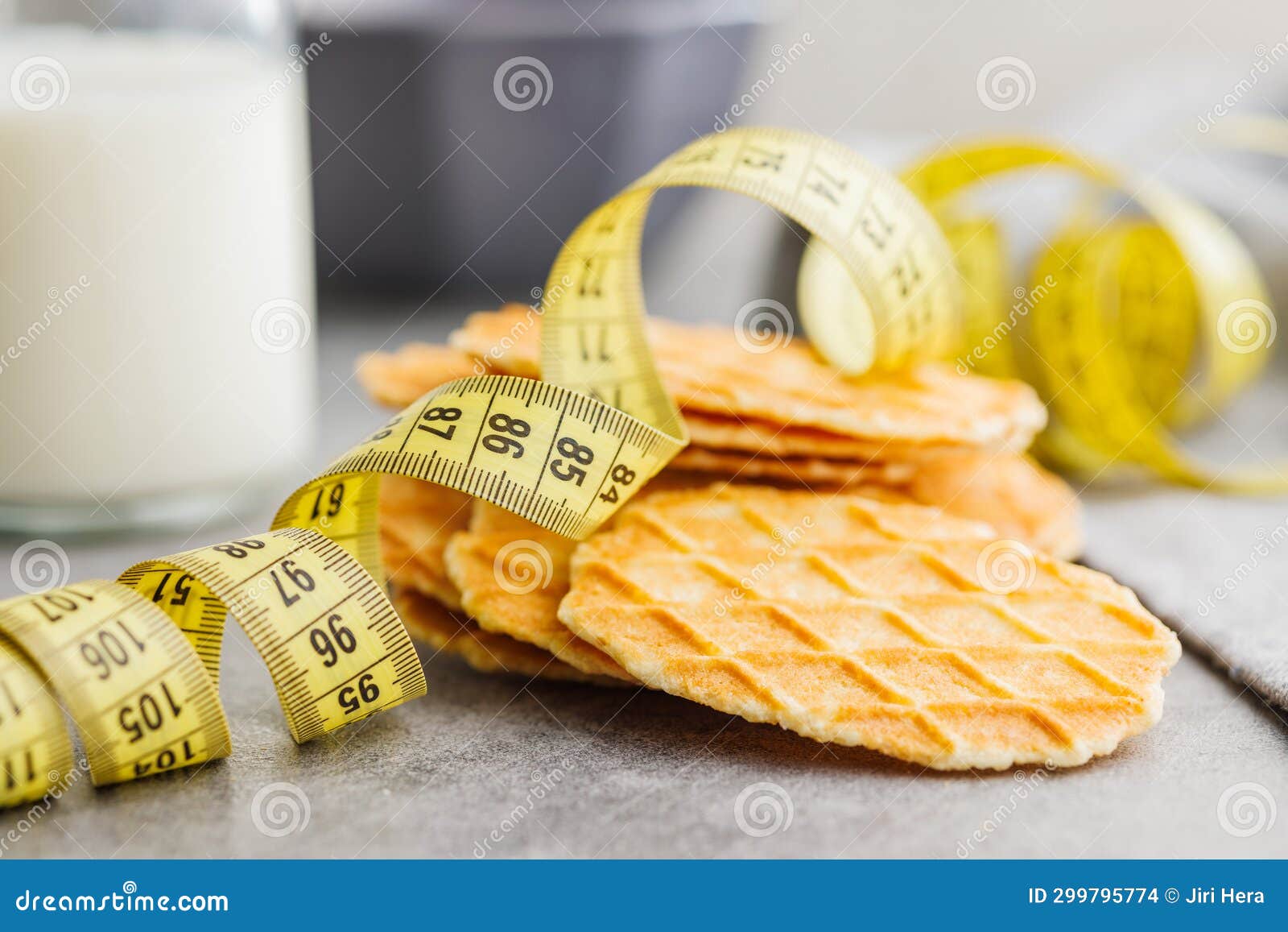 Round Waffle Biscuits and Measuring Tape on Kitchen Table Stock Photo ...